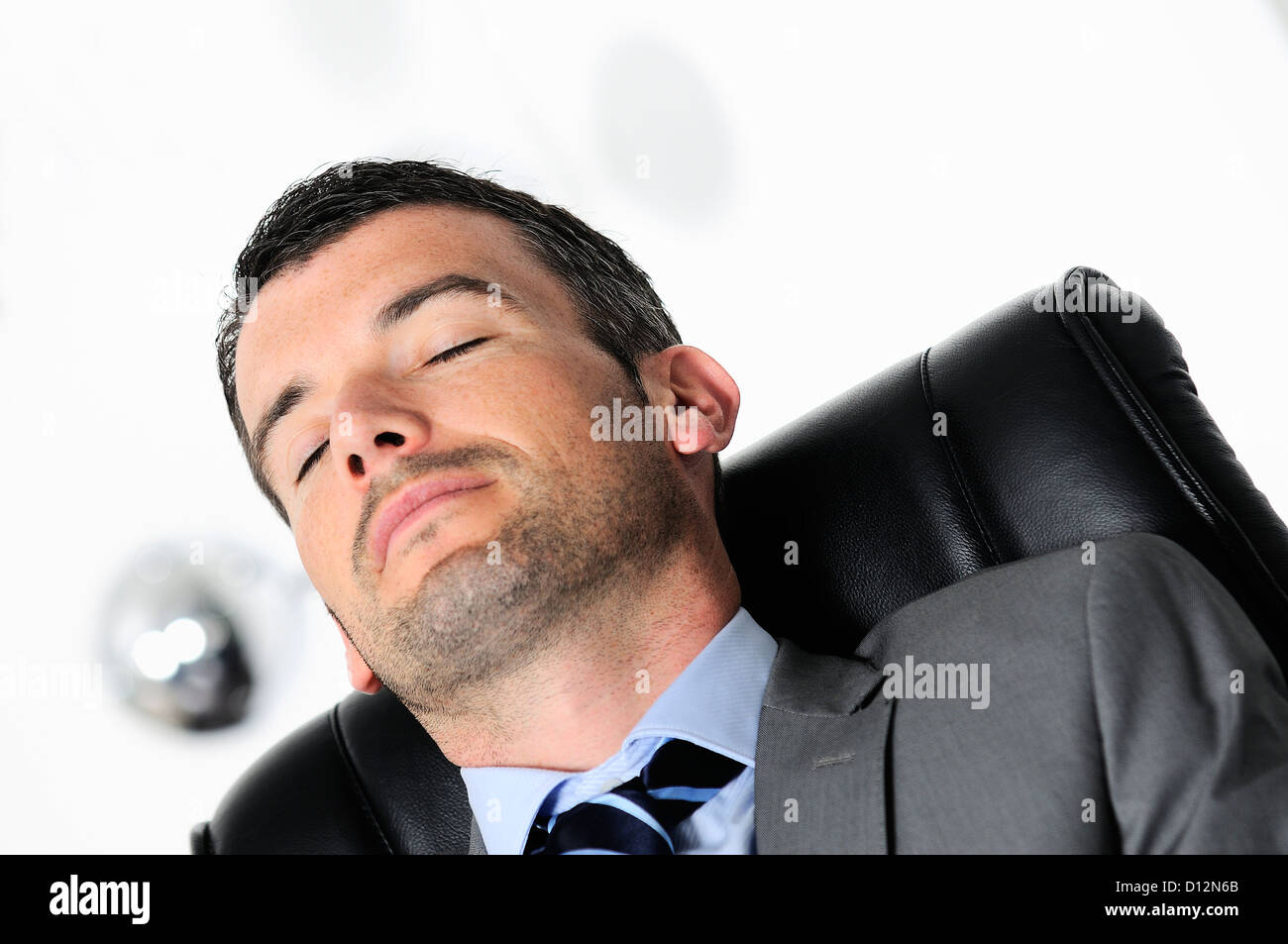 Attractive businessman is sleeping a while from business Stock Photo ...