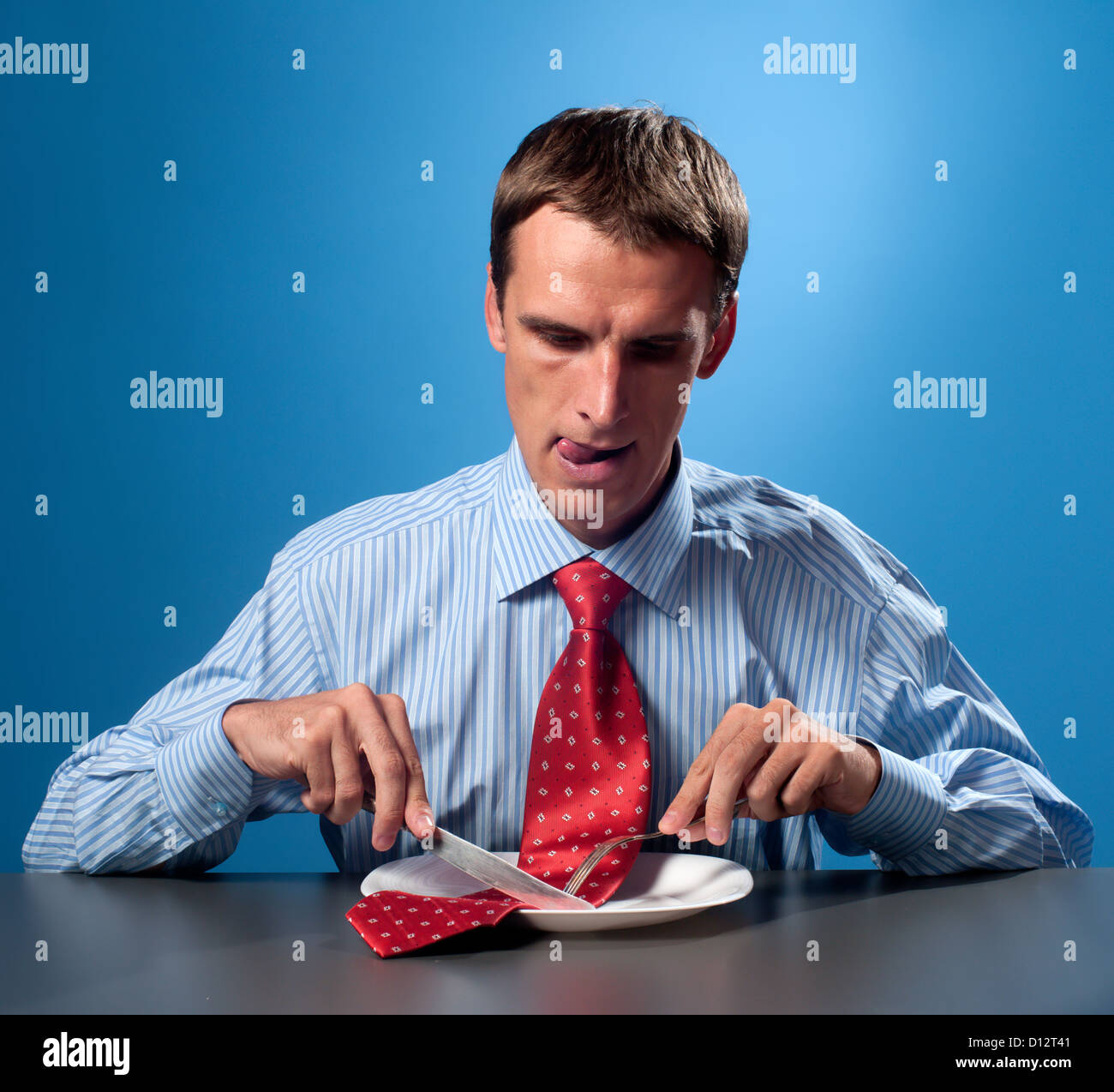young man eating his red tie Stock Photo - Alamy