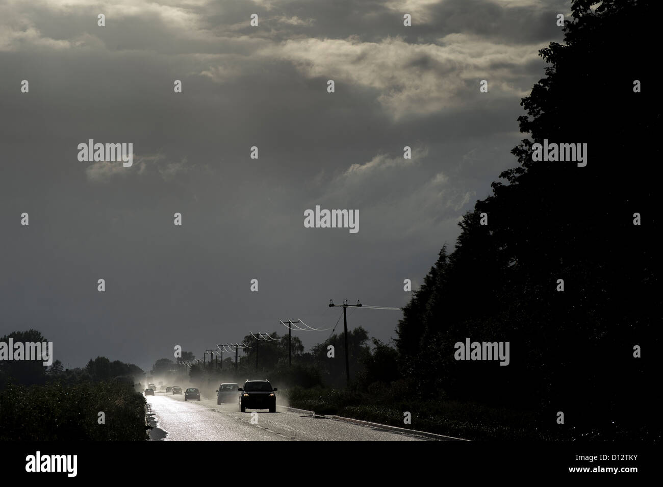 Dramatic view of cars driving through a storm on a single carriageway ...