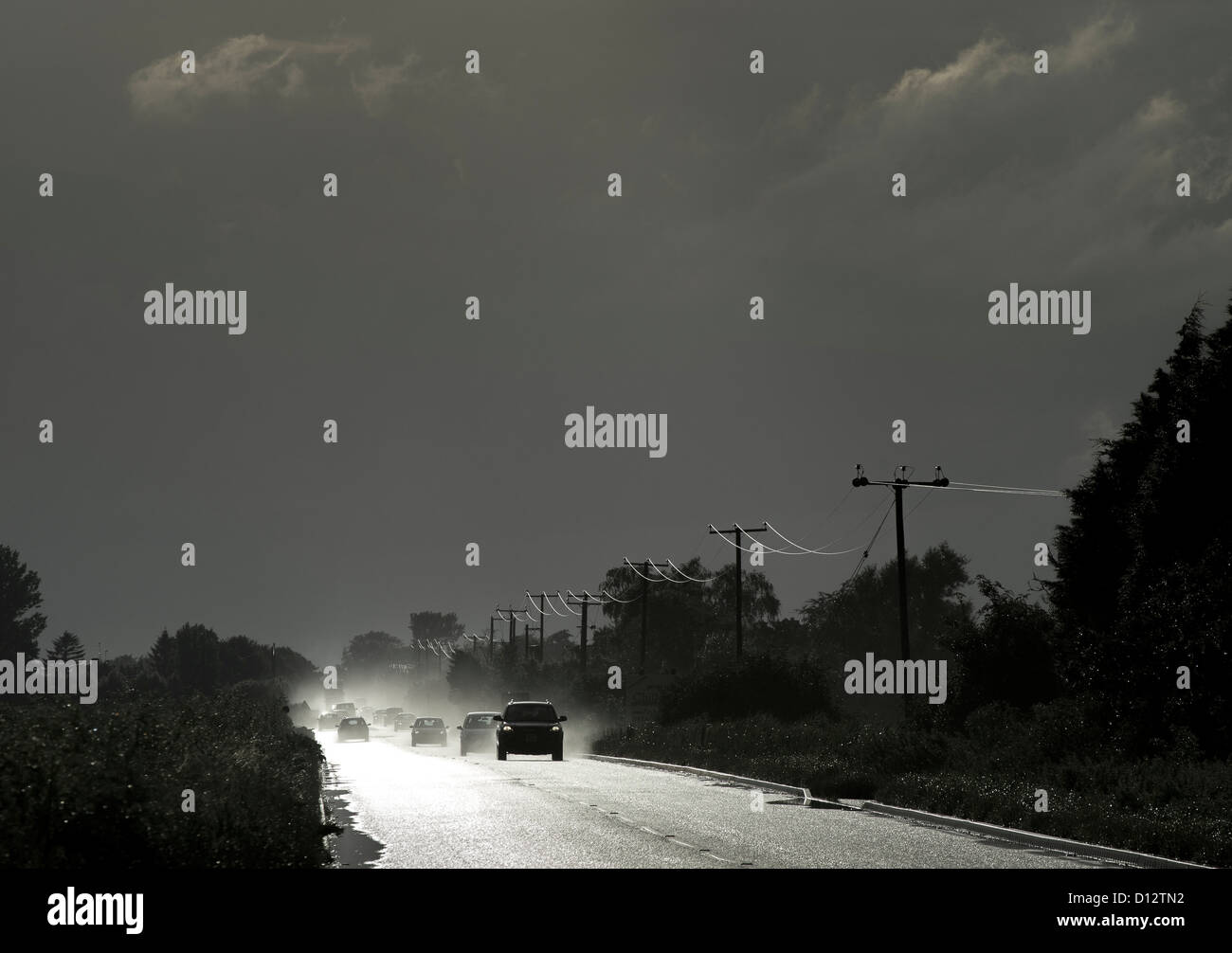 Dramatic view of cars driving through a storm on a single carriageway ...