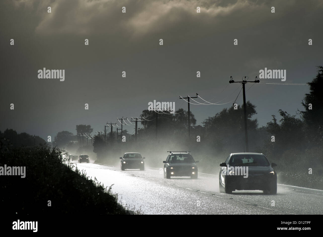 Dramatic view of cars driving through a storm on a single carriageway ...