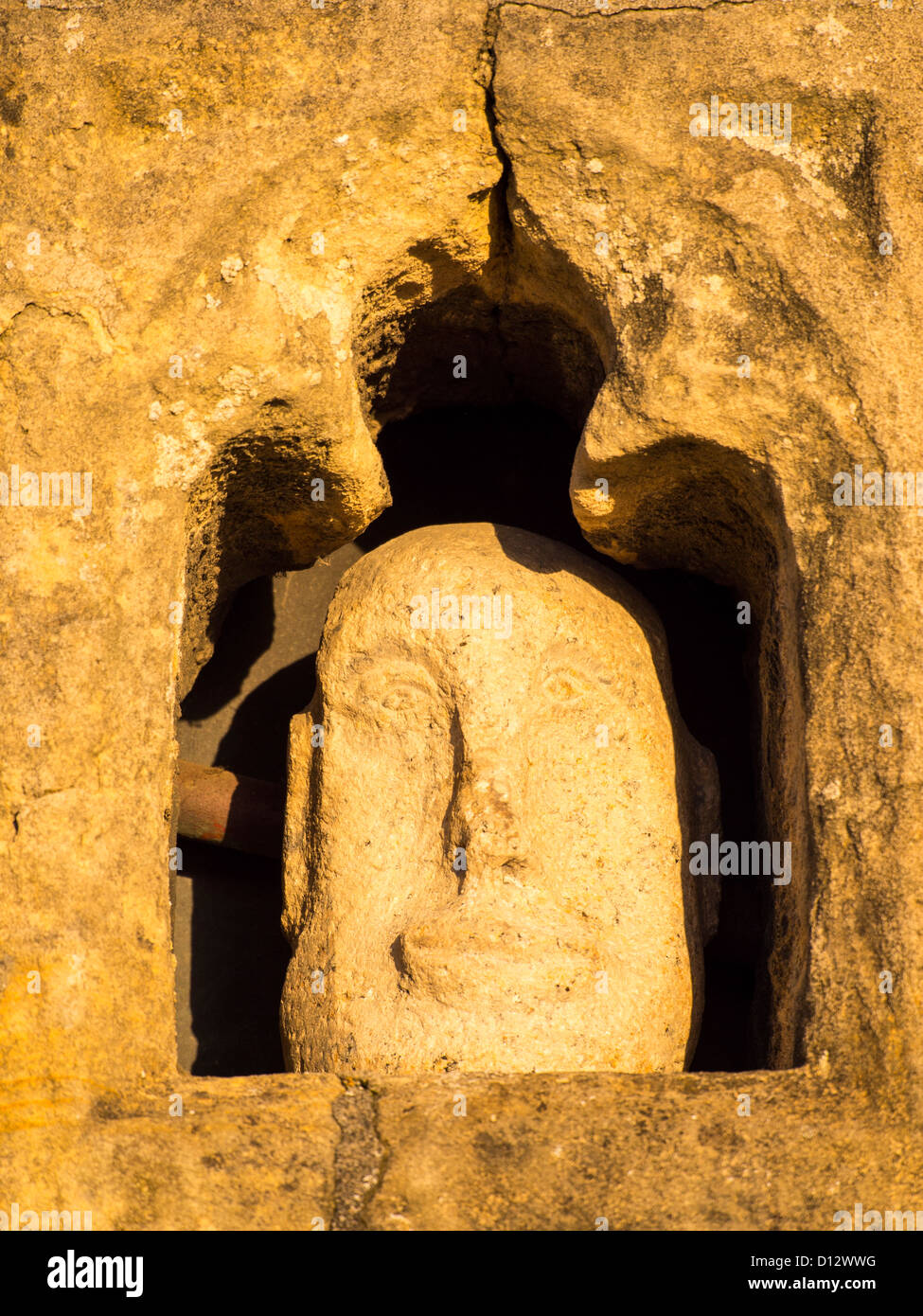 An ancient stone head on a 16th Century house on the harbour at Padstow ...