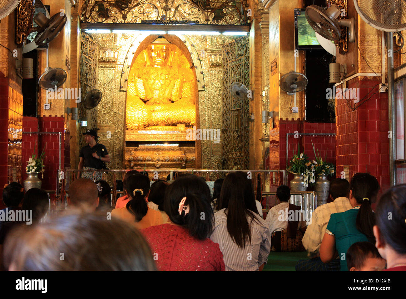 People are pictured in the altar room at the Mahamuni Pagoda in ...