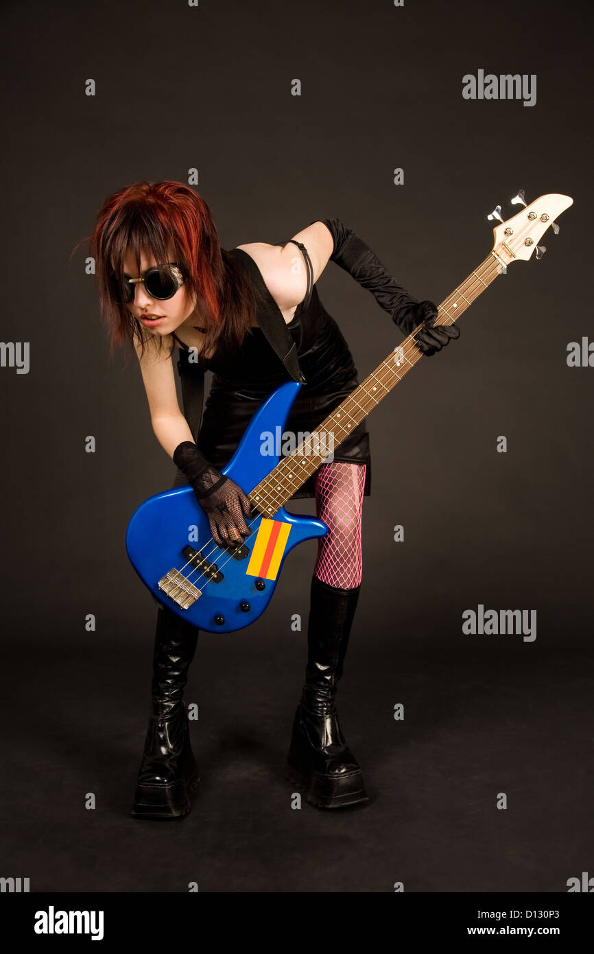 Strange musician with bass guitar isolated on black Stock Photo - Alamy