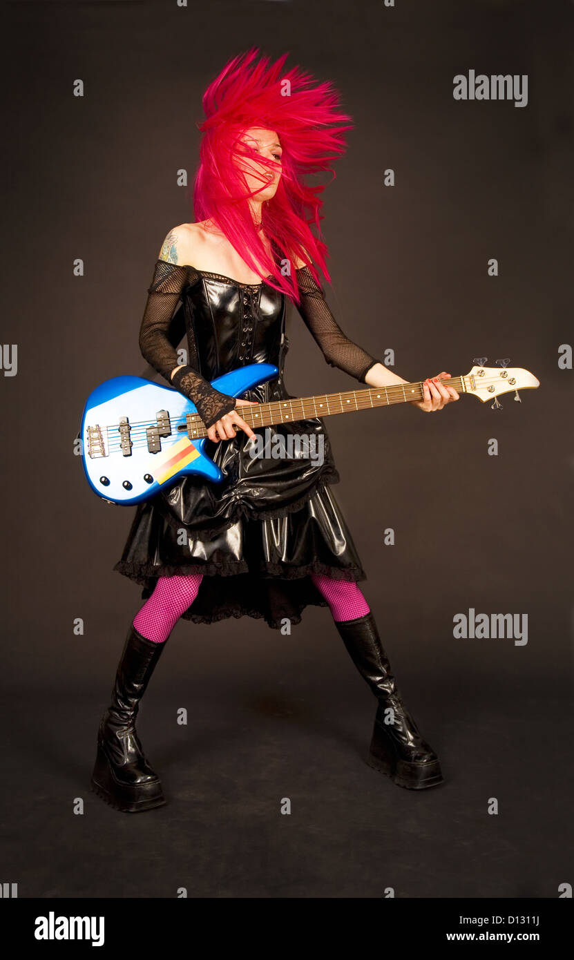 Rock girl with bass guitar shaking her head Stock Photo - Alamy
