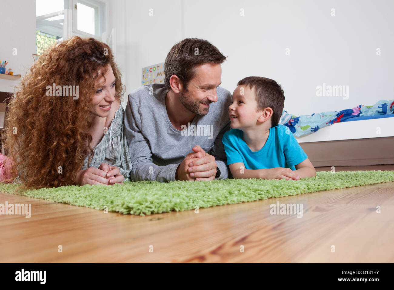 Germany, Berlin, Family on floor, smiling Stock Photo - Alamy