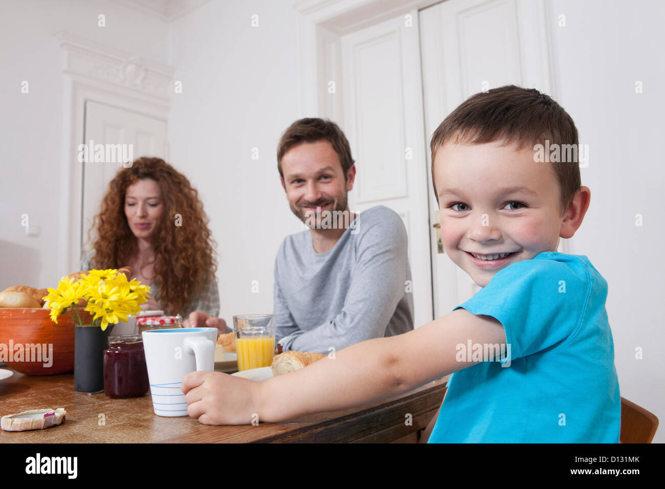 Germany, Berlin, Family having breakfast, smiling, portrait Stock Photo ...