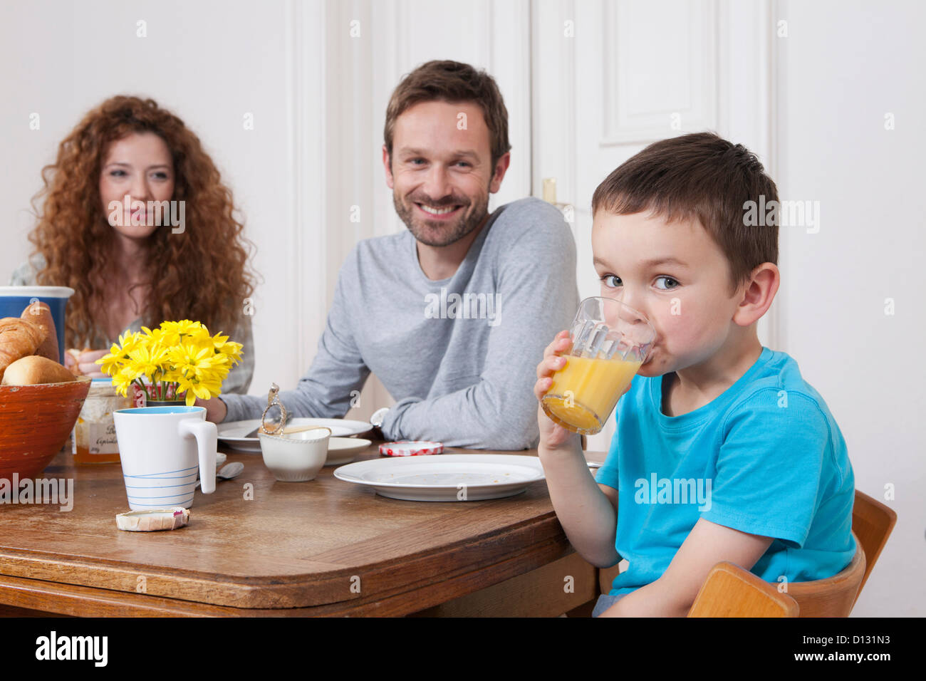 Germany, Berlin, Family having breakfast, smiling, portrait Stock Photo ...