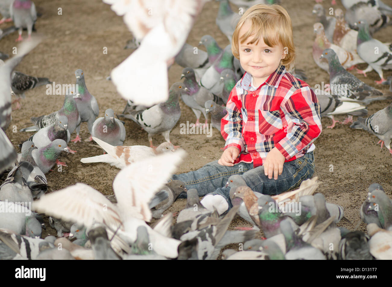 A Baby Smiling Surrounded by Doves Flying Around Stock Photo - Alamy
