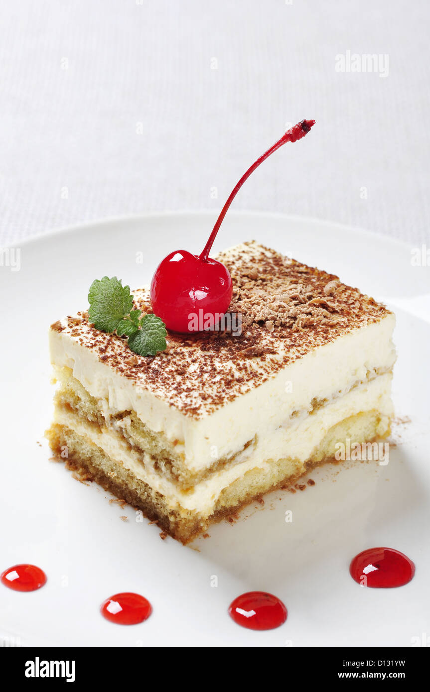 Tiramisu - Classical Dessert with Coffee on white plate. Garnished with ...