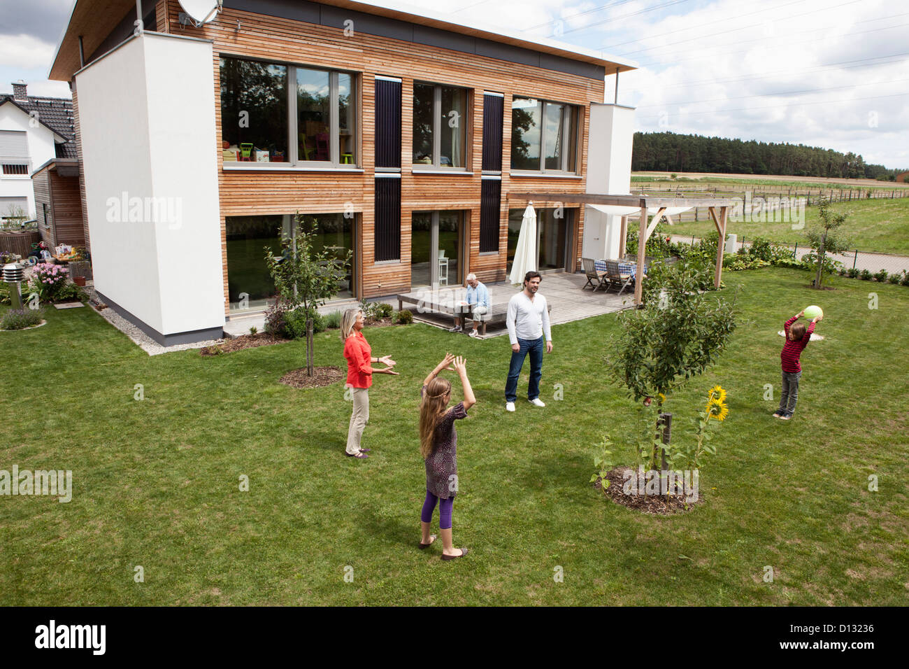 Germany, Bavaria, Nuremberg, Family playing in garden Stock Photo - Alamy