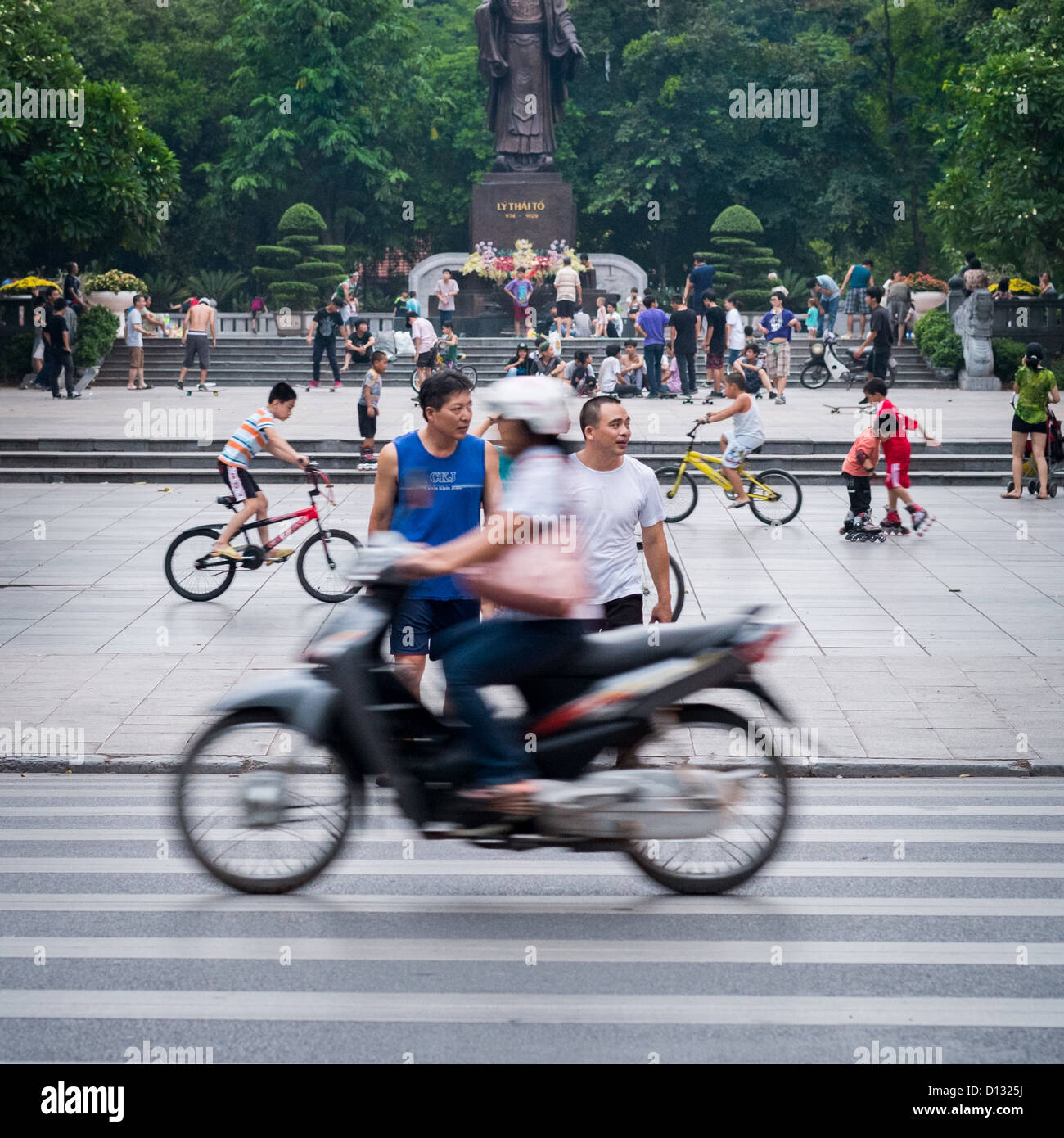 Two males walking across a zebra crossing in Hanoi Vietnam South East ...