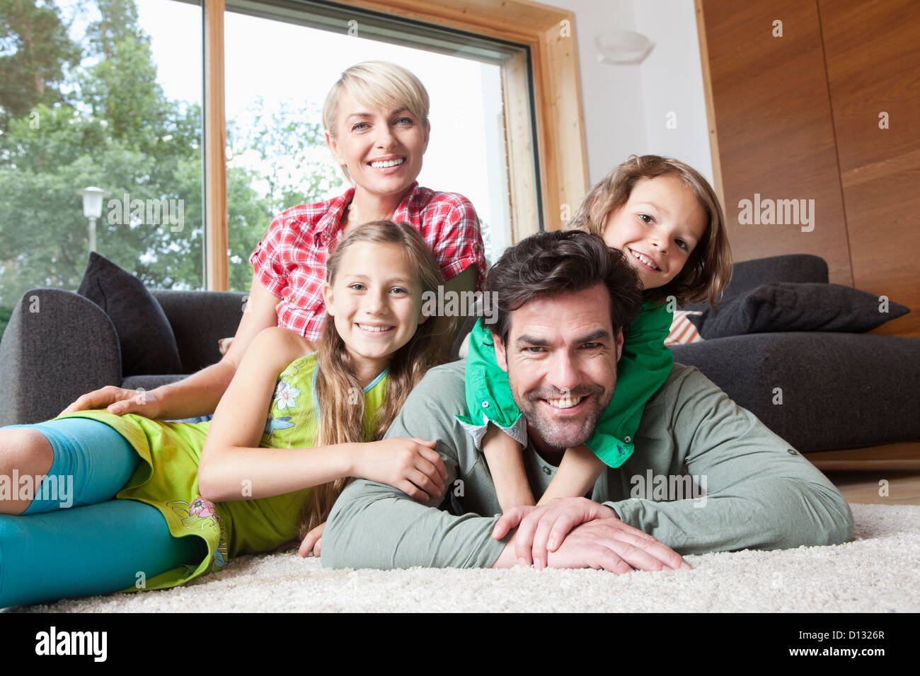 Germany, Bavaria, Nuremberg, Portrait of family in living room Stock ...