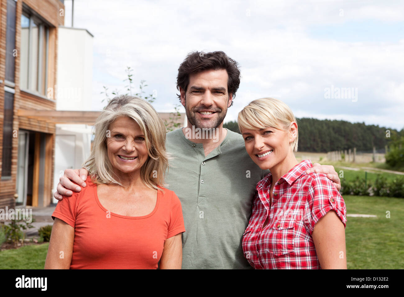 Germany, Bavaria, Nuremberg, Family in front of house, smiling Stock ...