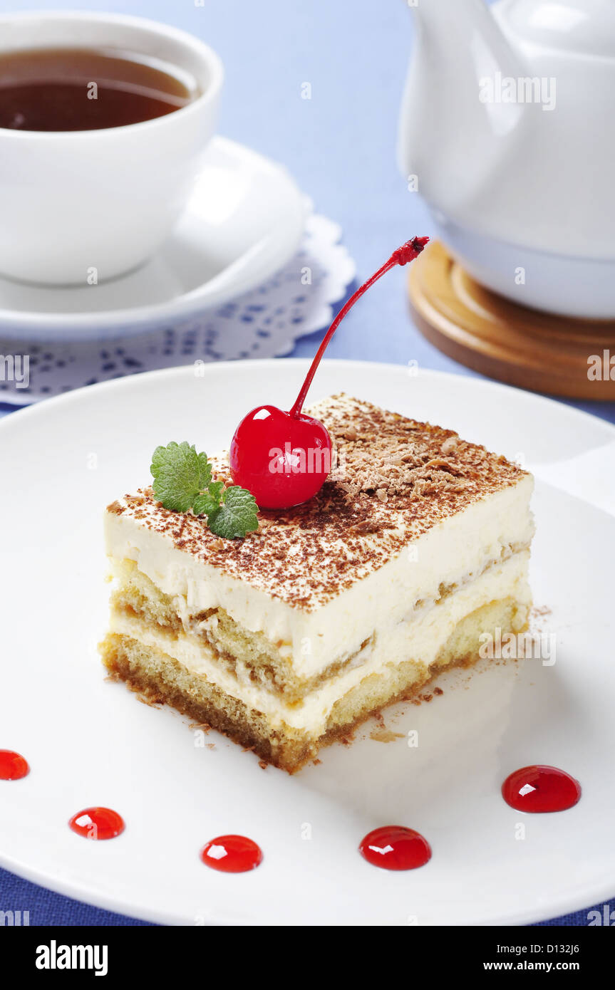 Tiramisu - Classical Dessert with Coffee on white plate. Garnished with ...