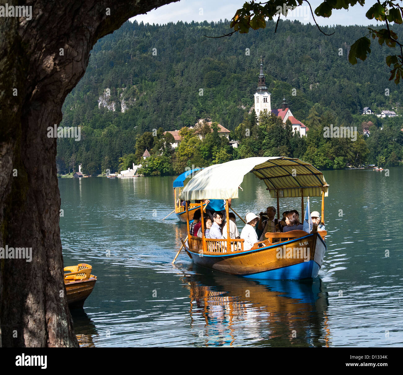 The traditional way to reach the lake's island is by a pletna boat. A ...