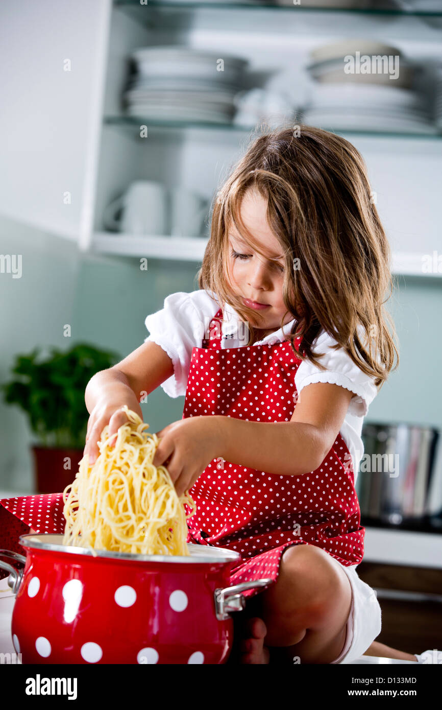 Germany, Girl playing with spaghetti Stock Photo - Alamy