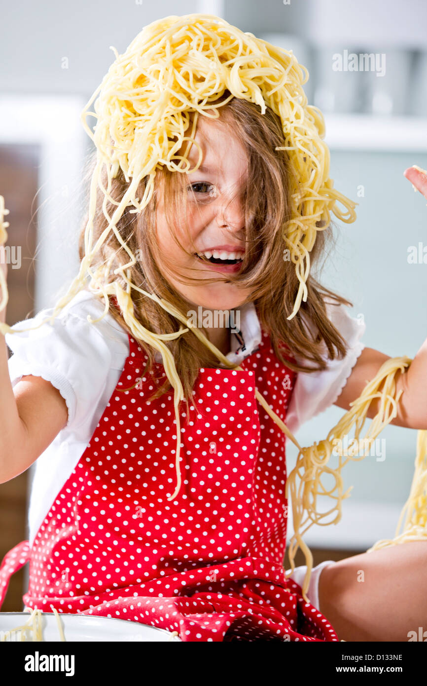 Germany, Girl playing with spaghetti Stock Photo - Alamy