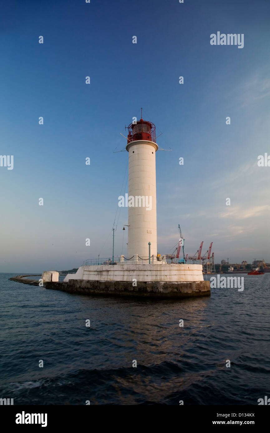 Lighthouse, industrial docks on background Stock Photo - Alamy