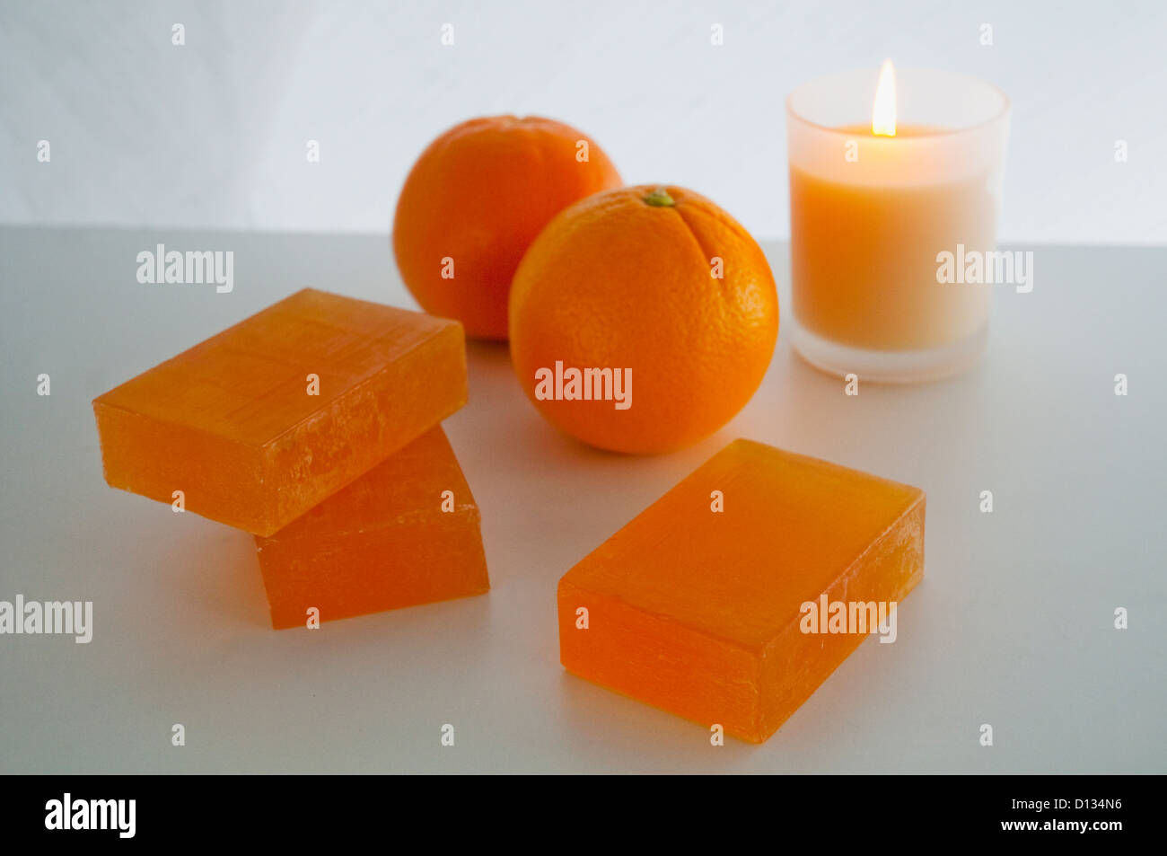 Soap, oranges and lit up candle Stock Photo - Alamy