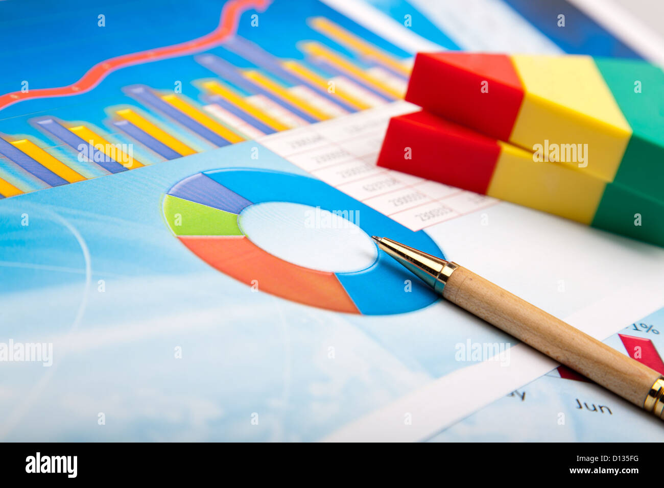 Financial report with ball pen and models Stock Photo - Alamy