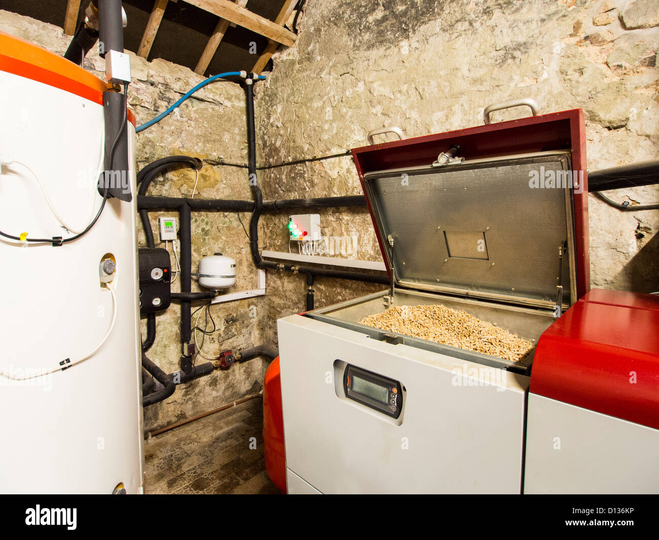 A biofuel boiler that burns wood pellets and a large hot water tank ...