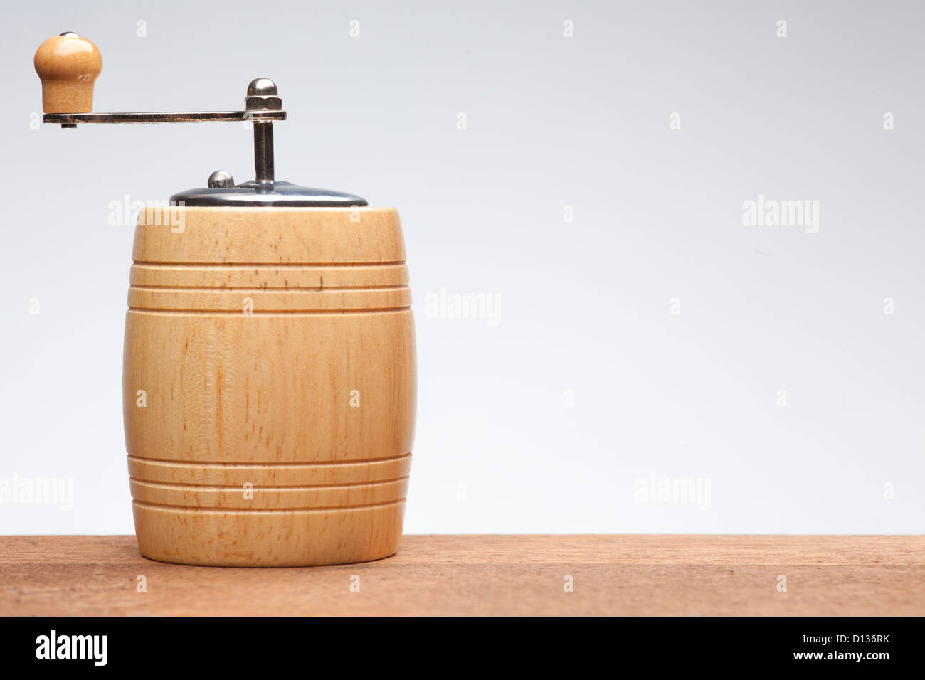 wooden pepper mill on white background with empty space on right side ...