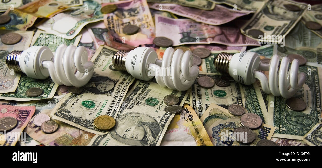 Compact Florescent Lightbulb Laying In Money Stock Photo - Alamy