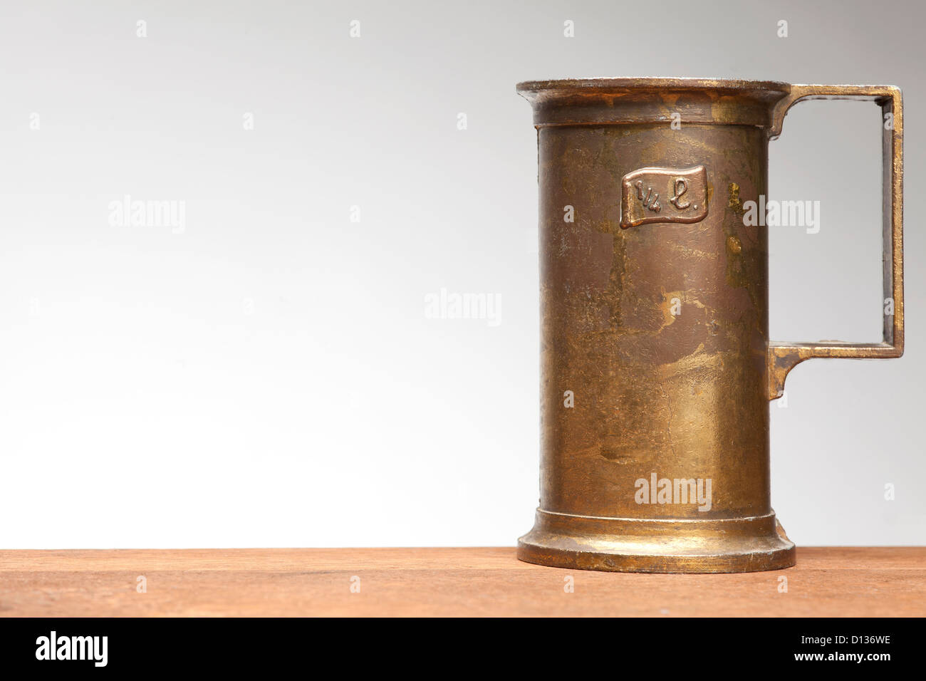 quarter liter brass measure on white background Stock Photo - Alamy