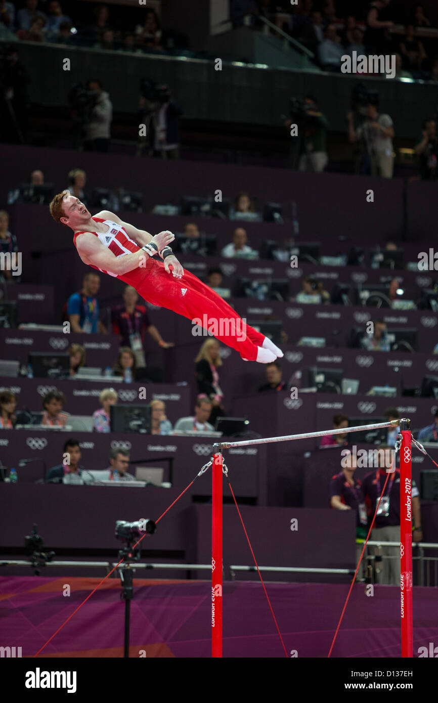 Daniel Purvis (GBR) competing on the high bar during the men's team ...