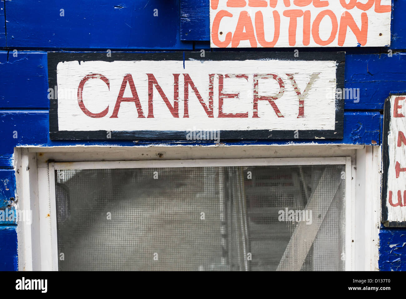 A faded hand-painted sign indicating 'cannery' above a door at an ...
