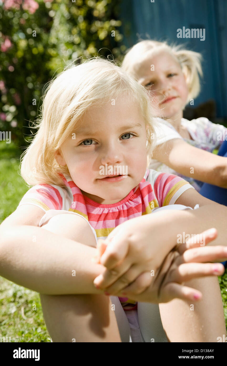 Germany, Bavaria, Girls sitting in garden, portrait Stock Photo - Alamy