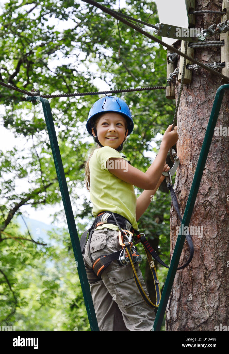 Happy girl at the ropes course Stock Photo - Alamy