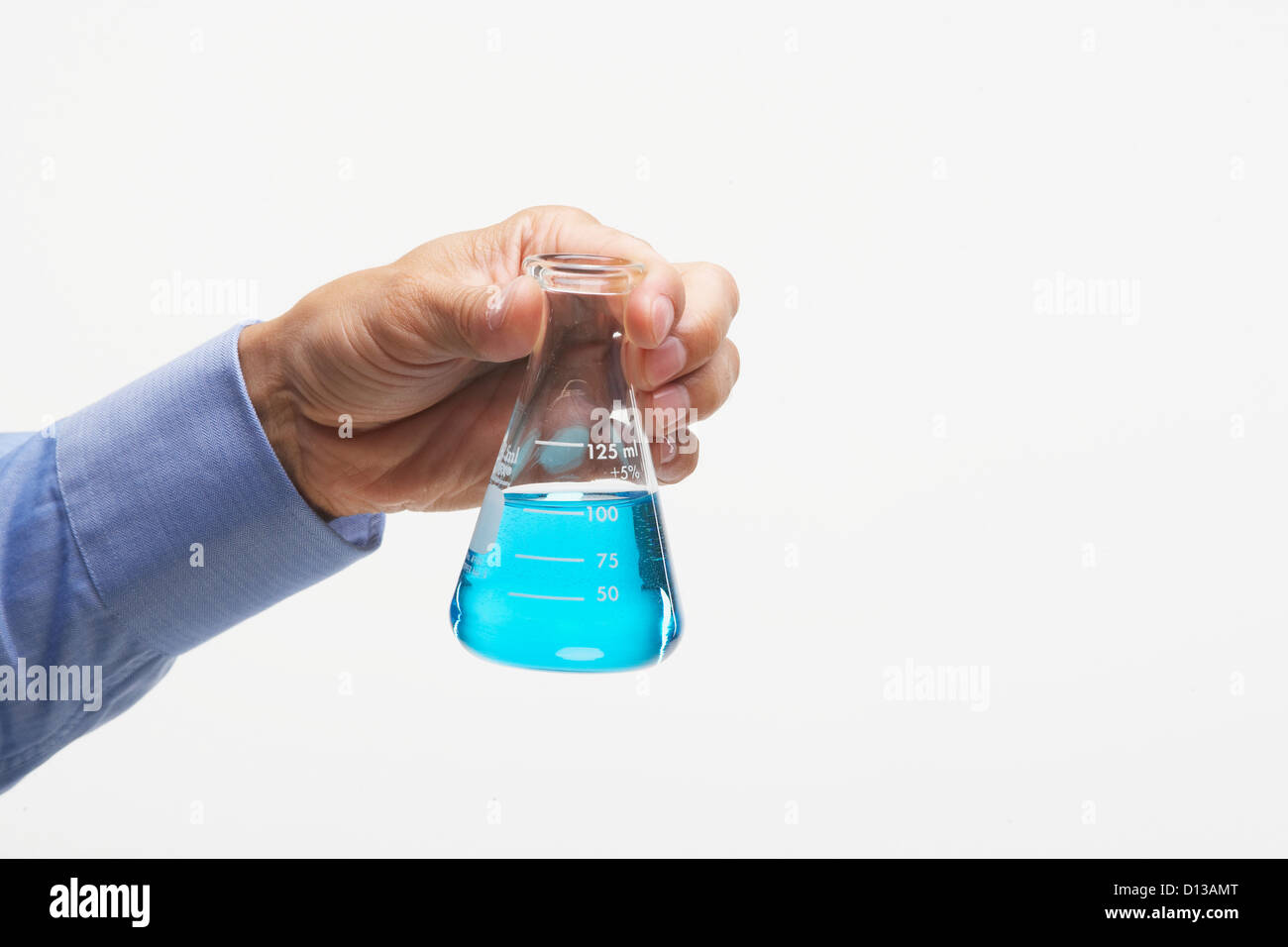 Hand Holding Beaker Of Blue Liquid Stock Photo - Alamy