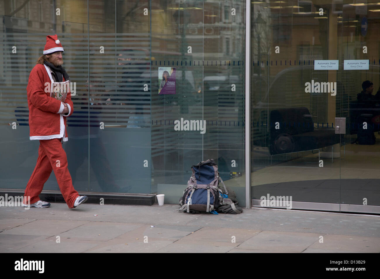 6th December 2012. London UK. A man dressed in a Santa costume selling ...