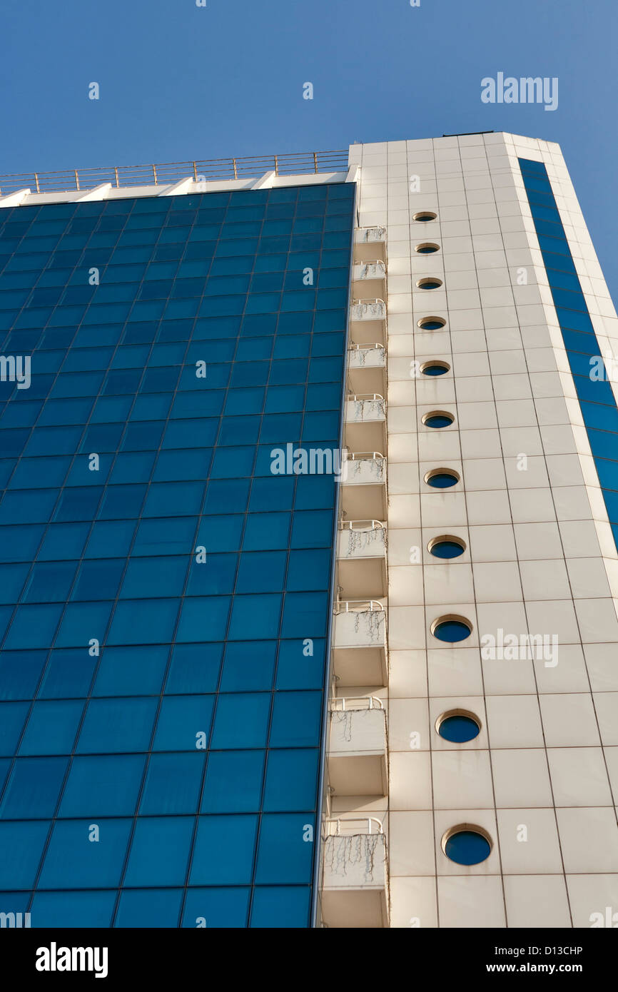 Modern high-rise building against blue sky Stock Photo - Alamy