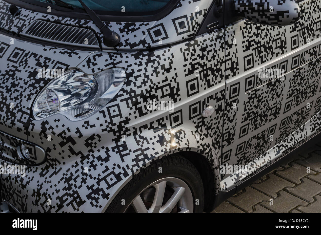 Small car covered with QR code Stock Photo - Alamy