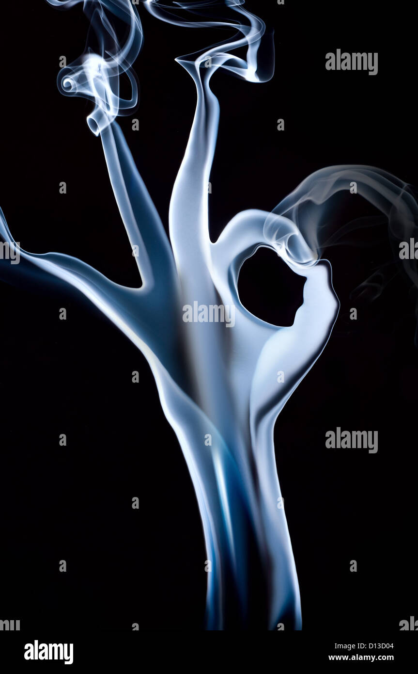 Smoke hand with OK sign on black Stock Photo - Alamy