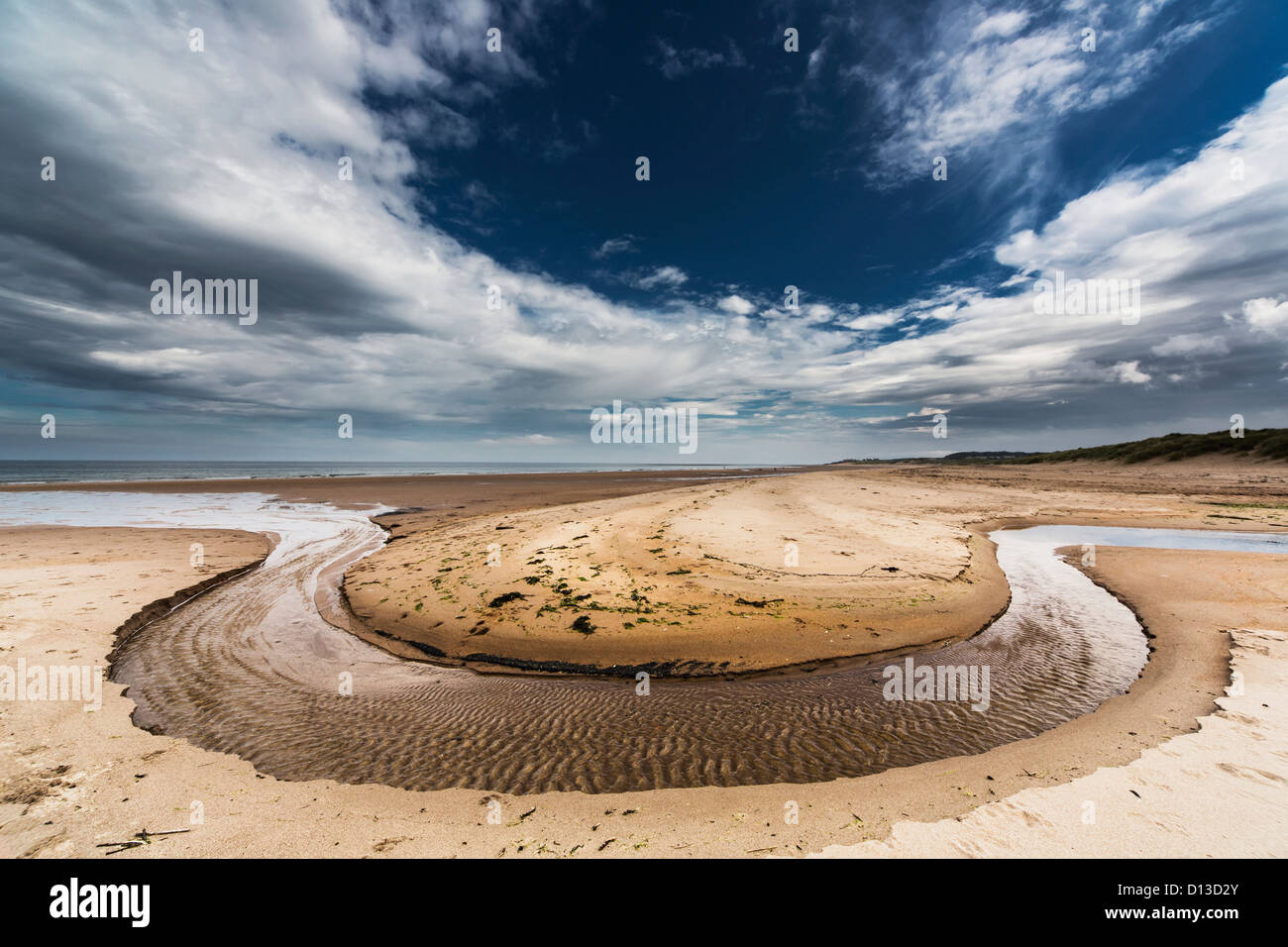 A Stream Formed In A Circular Shape In The Sand Along The Coast ...