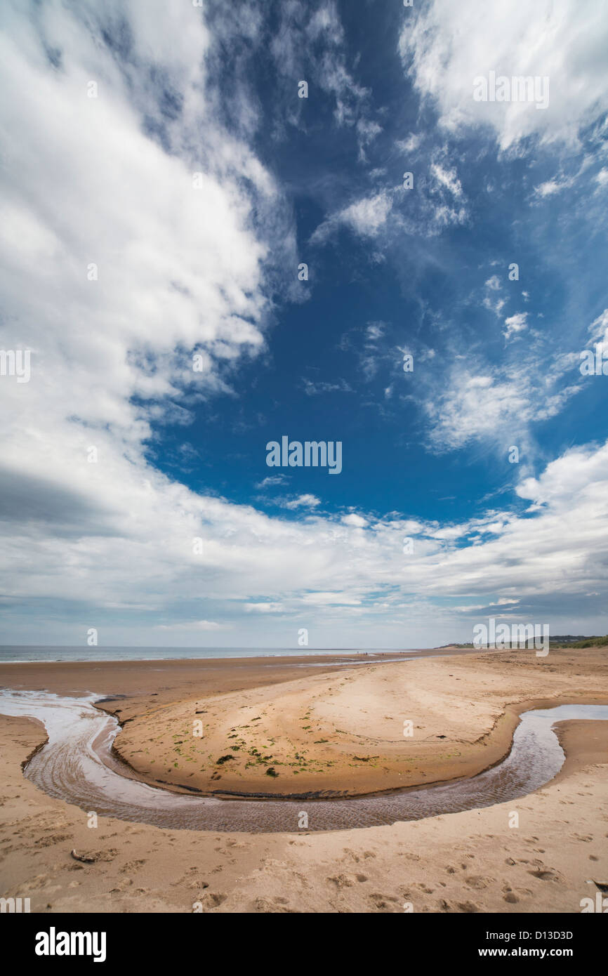 A Stream Formed In A Circular Shape In The Sand Along The Coast ...