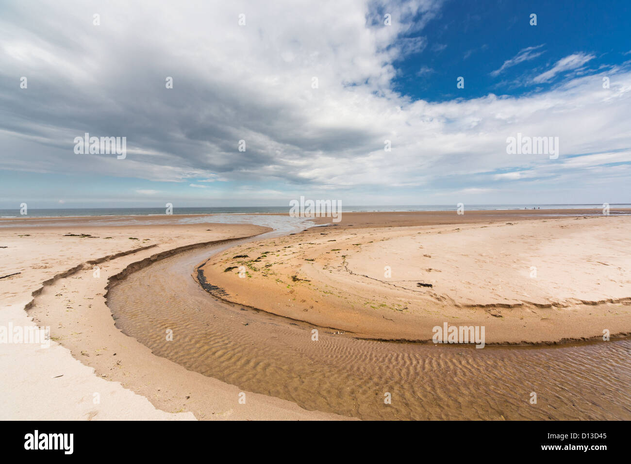 A Stream Formed In A Circular Shape In The Sand Along The Coast ...