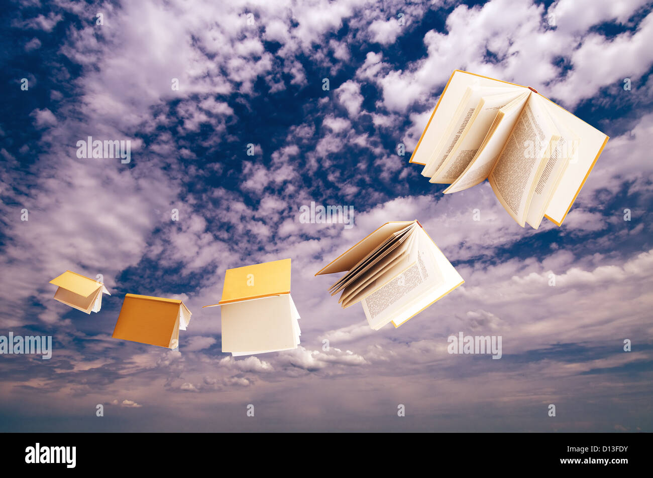 flock of books flying on blue sky background Stock Photo - Alamy