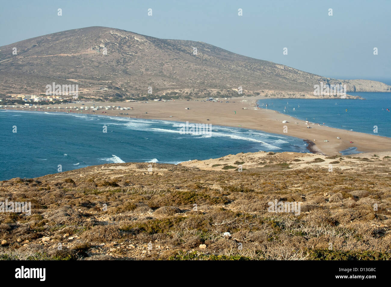 Sea landscape with land neck and surfers. Prassonissi cape, Western ...