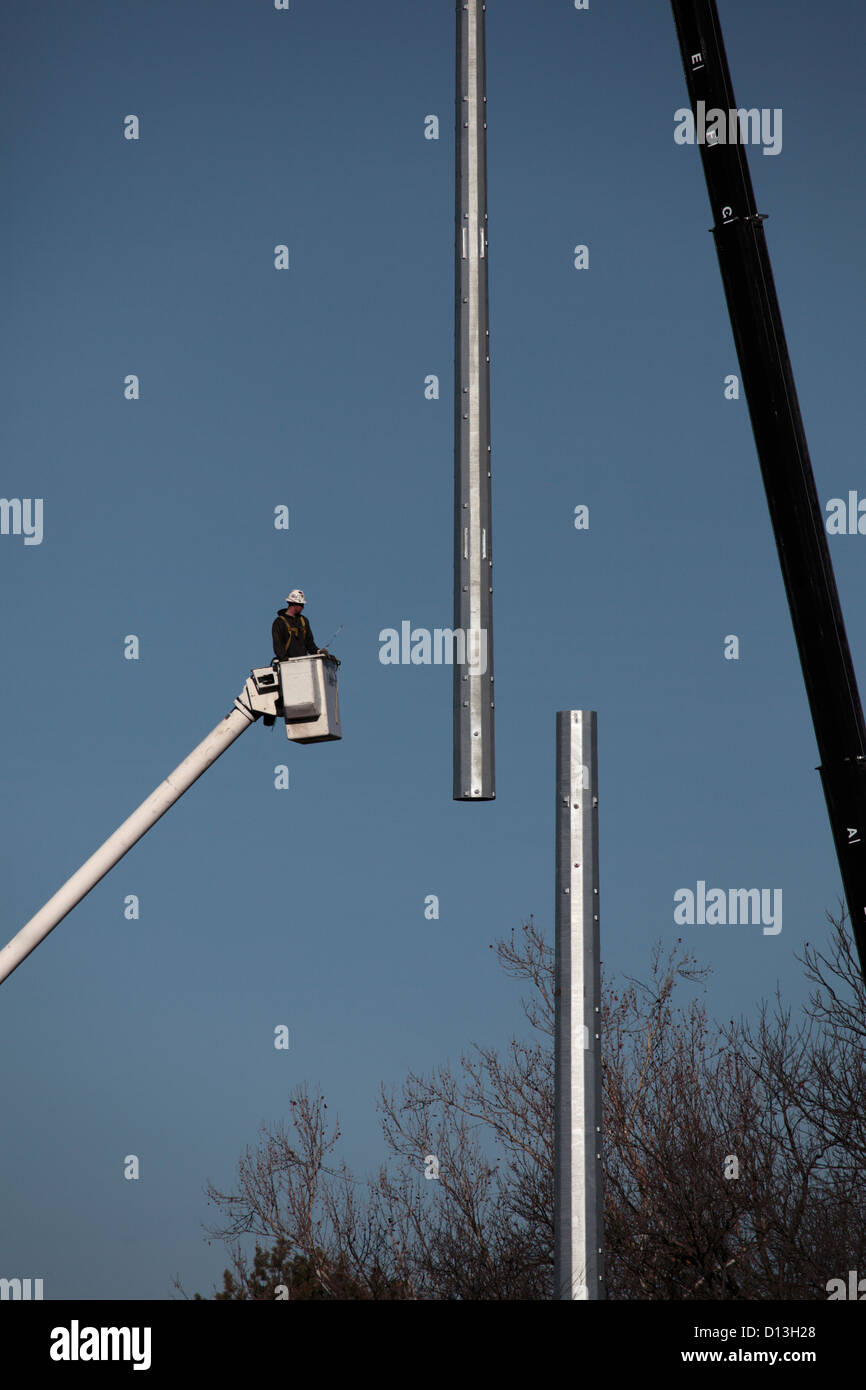 Crane lifting steel utility pole hi-res stock photography and images ...