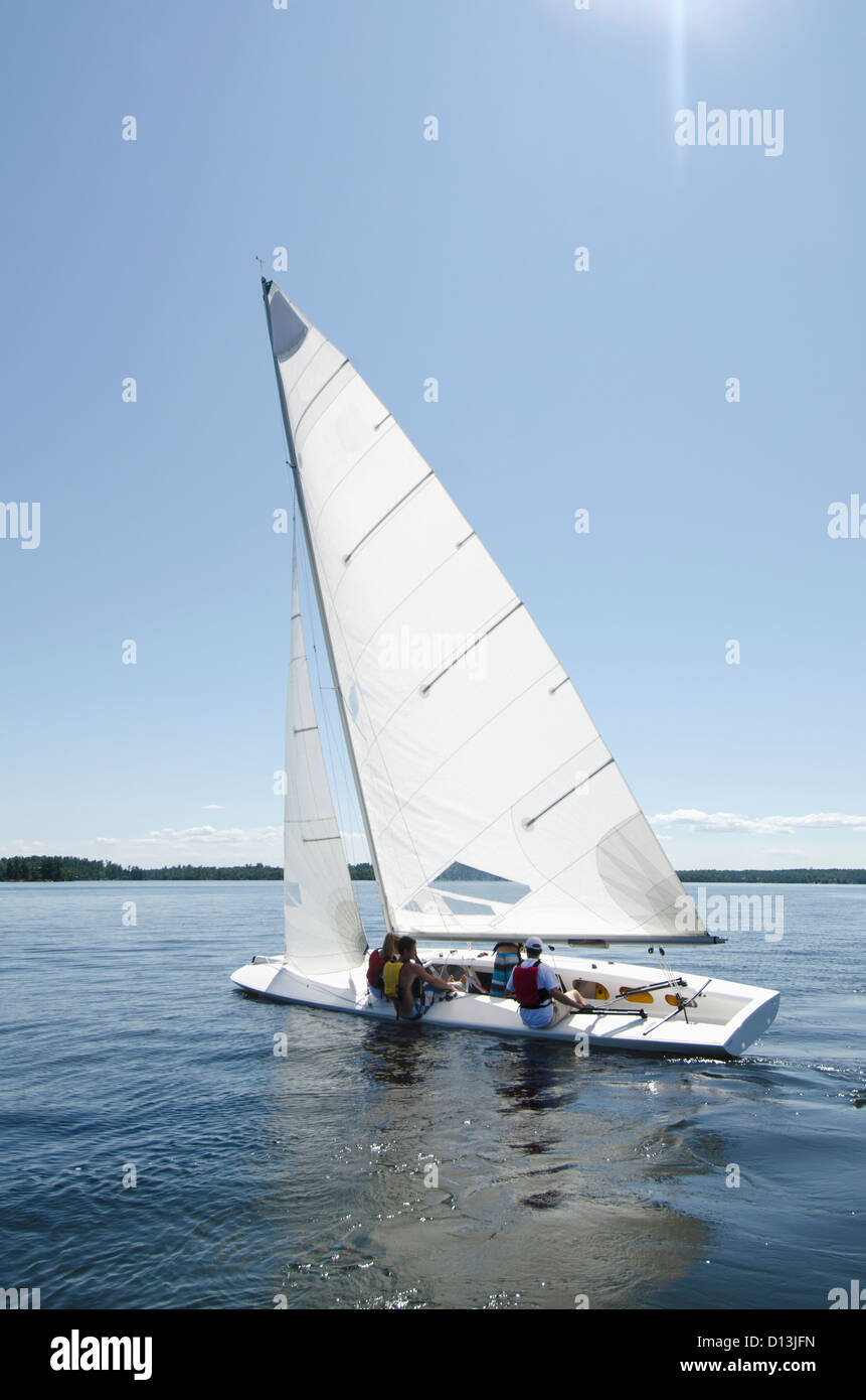 Young man on small sailing boat hi-res stock photography and images - Alamy