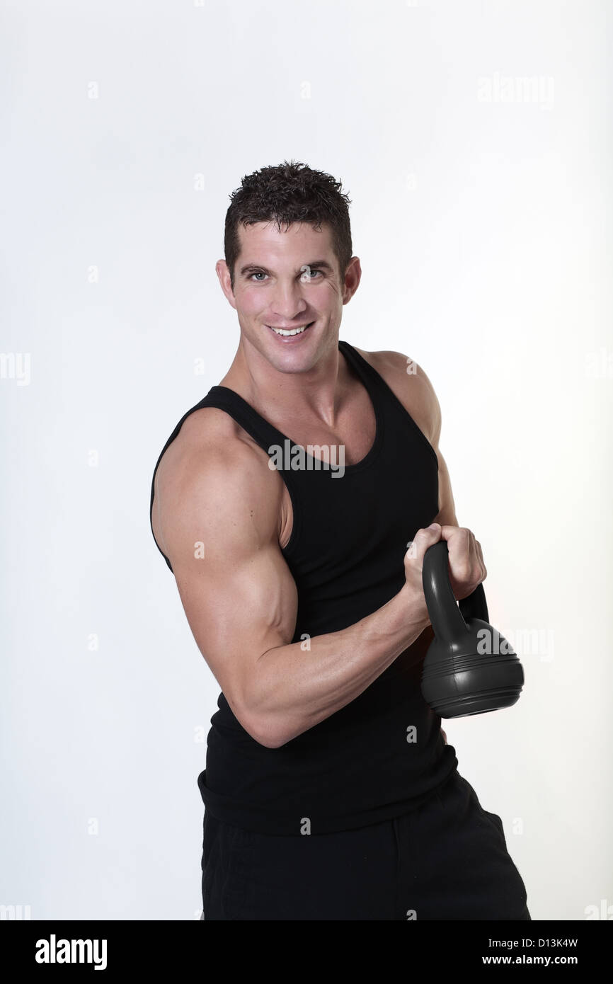 male bodybuilding doing a work out lifting kettlebell Stock Photo - Alamy