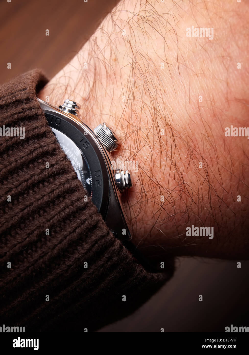 Closeup view on a wrist watch under the sleeve Stock Photo - Alamy