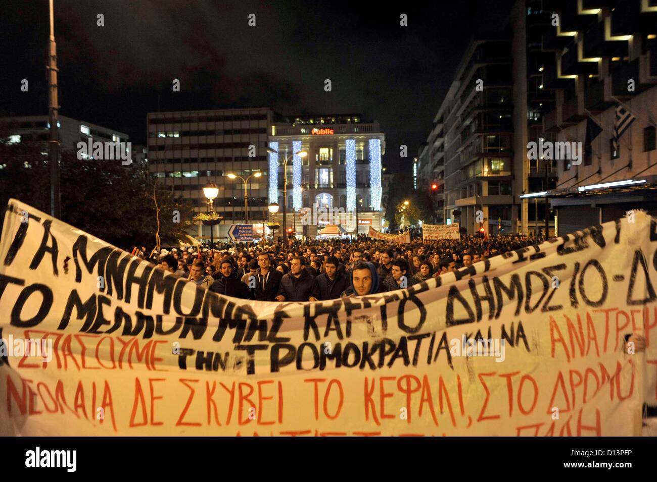 Athens, Greece. 6th December 2012. Demonstrators hold a placard and ...