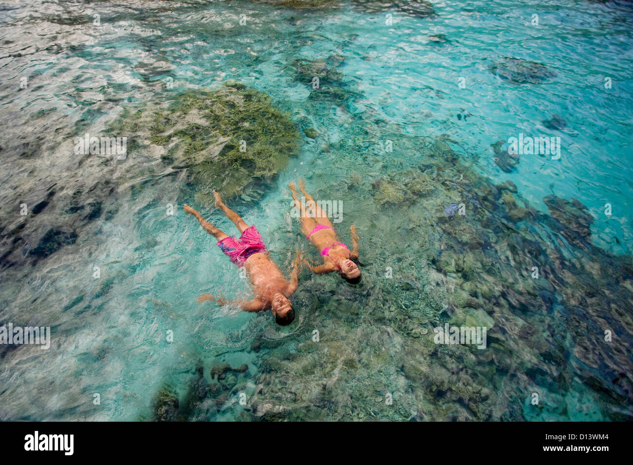 Couple Floating Together In Tropical Ocean Water Over Reef Stock Photo ...