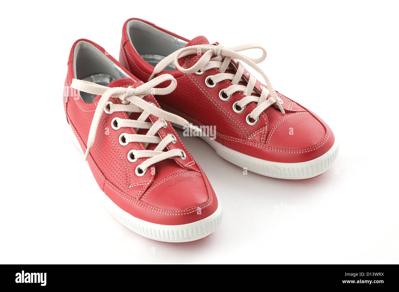 red leather sneakers on white Stock Photo - Alamy